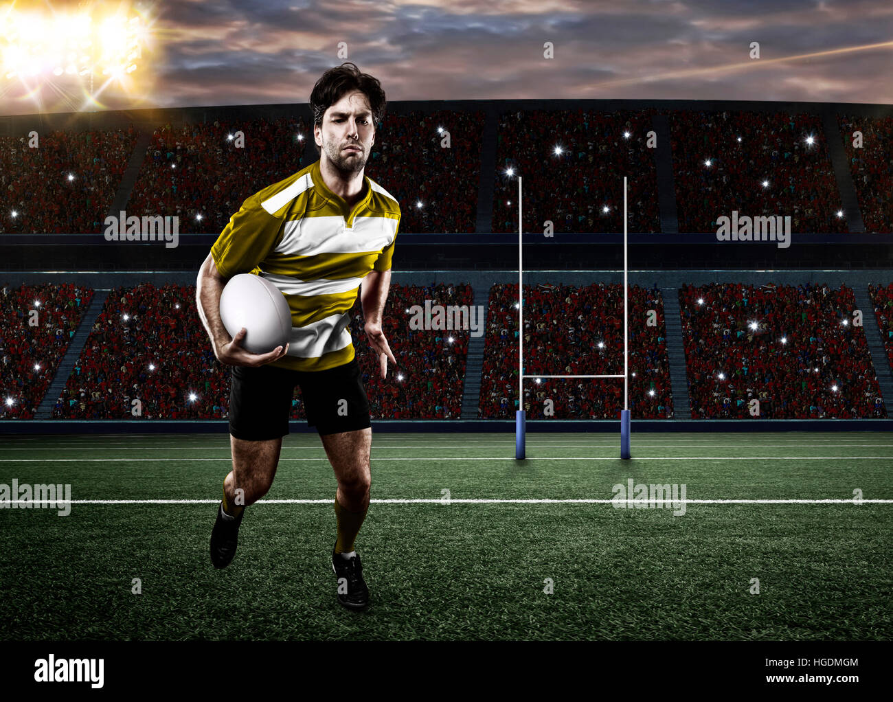 Rugby player in a yellow uniform running on a stadium Stock Photo - Alamy
