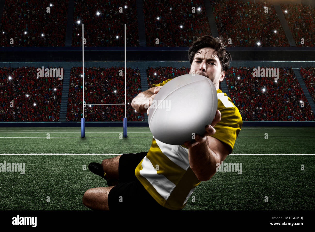 Rugby player in a yellow uniform scoring on a stadium Stock Photo - Alamy