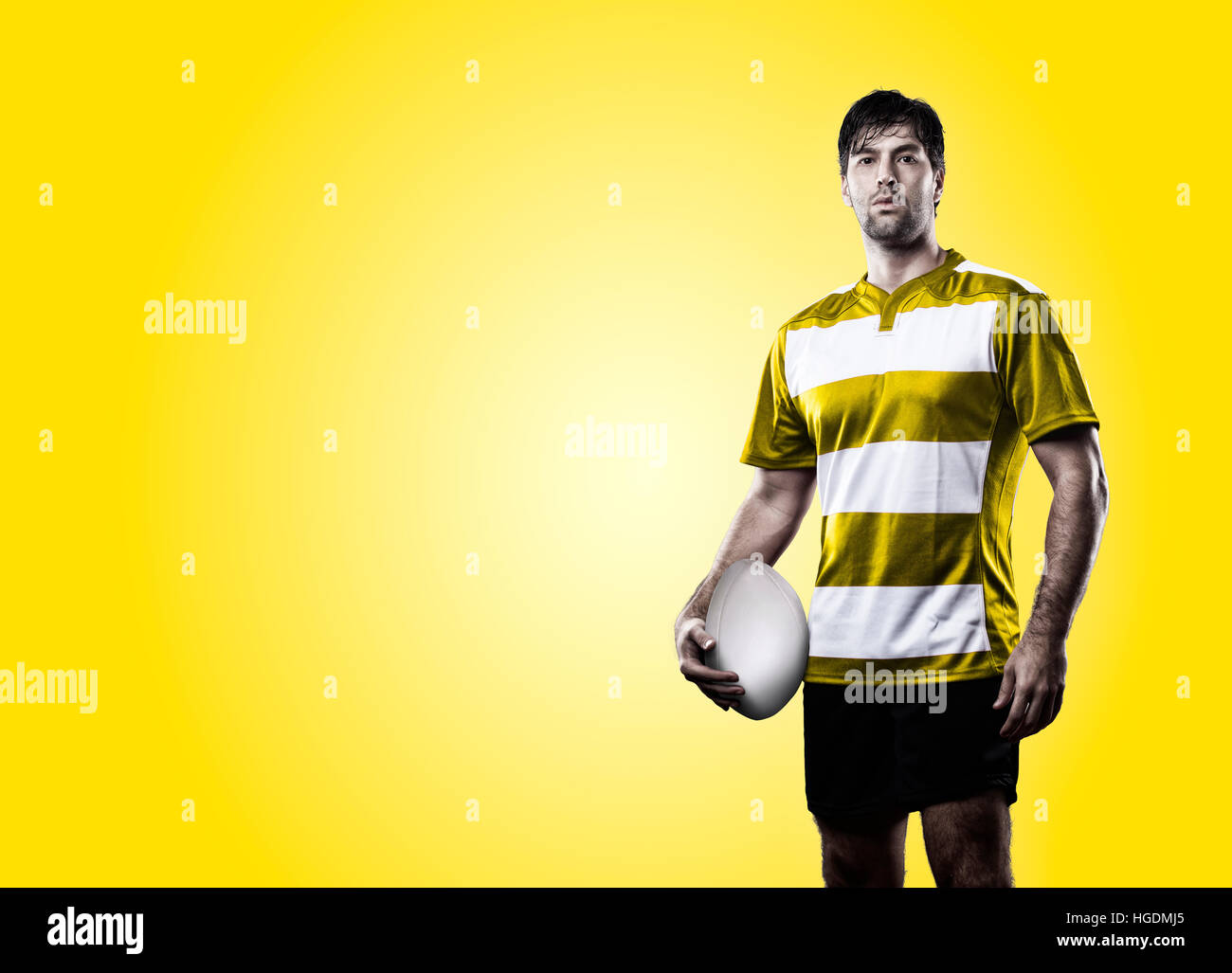 Rugby player in a yellow uniform on a yellow background Stock Photo - Alamy