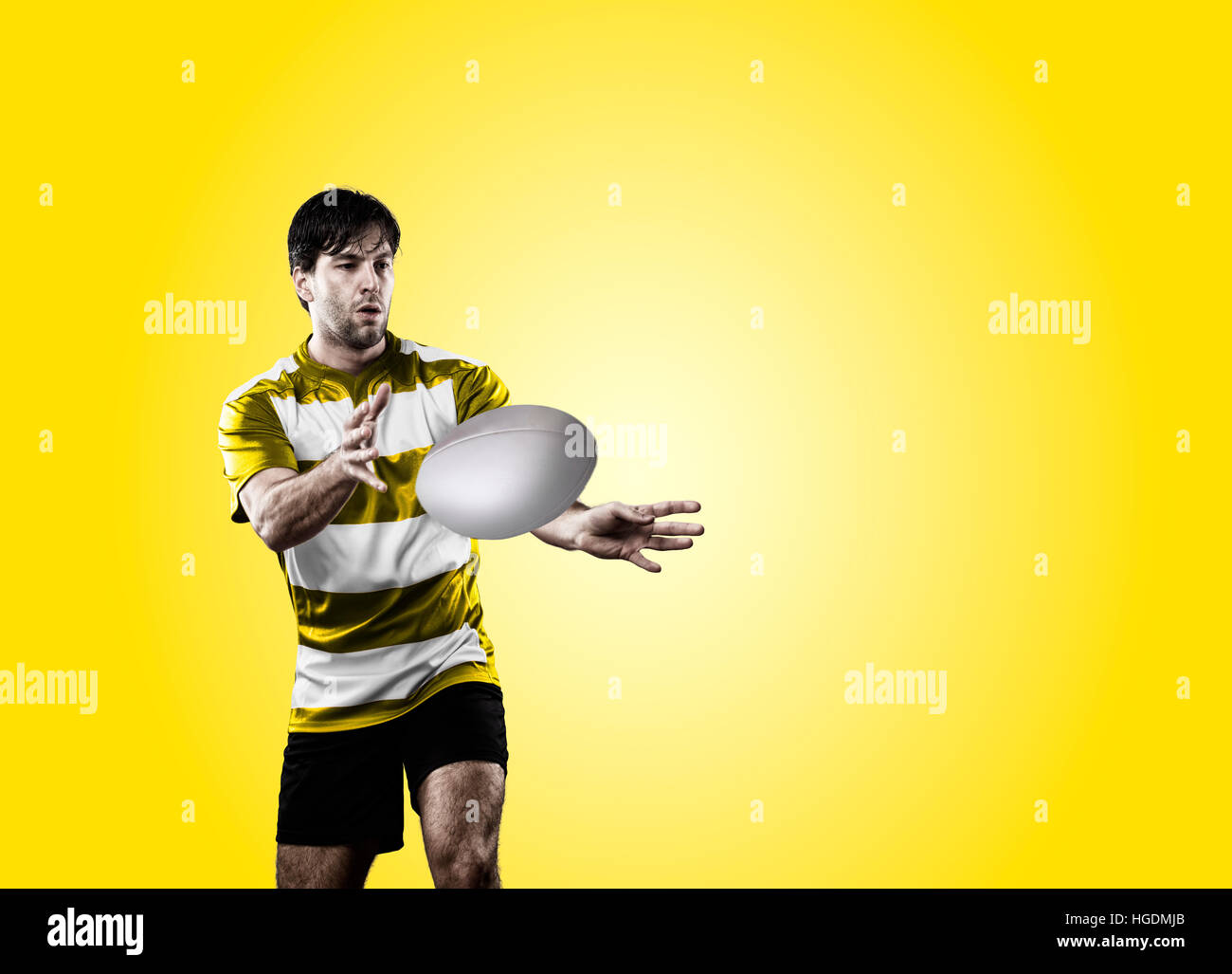 Rugby player in a yellow uniform on a yellow background Stock Photo - Alamy