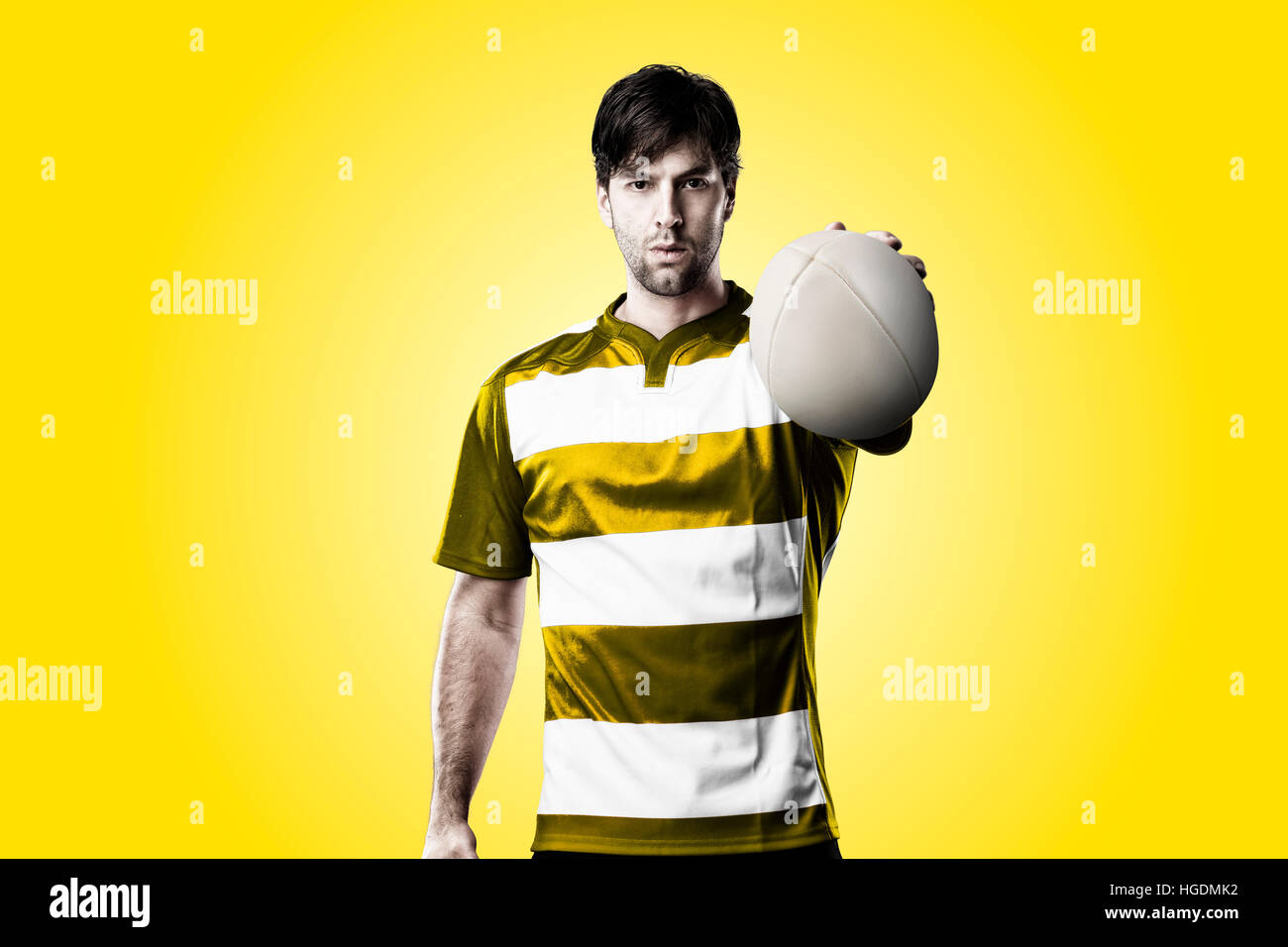 Rugby player in a yellow uniform on a yellow background Stock Photo - Alamy