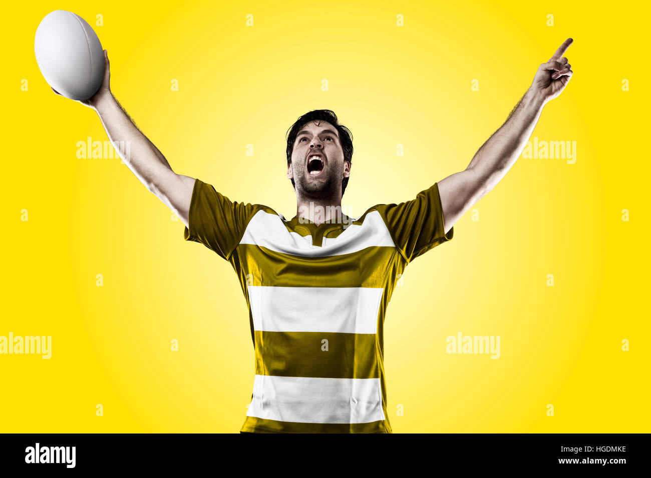 Rugby player in a yellow uniform celebrating on a yellow background ...