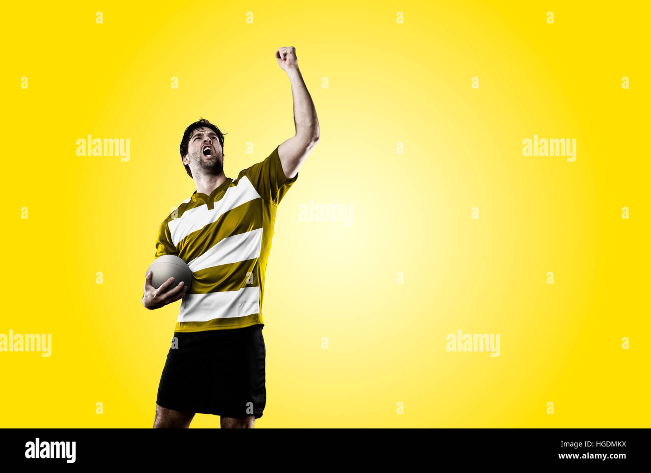 Rugby player in a yellow uniform celebrating on a yellow background ...
