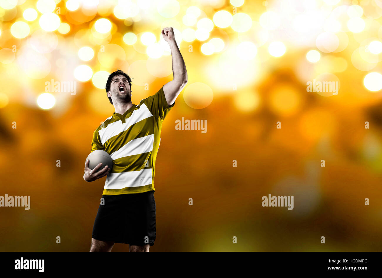 Rugby player in a yellow uniform celebrating on a yellow lights ...