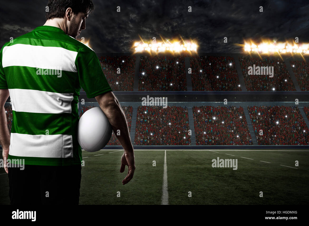 Rugby player in a green uniform on a stadium Stock Photo - Alamy