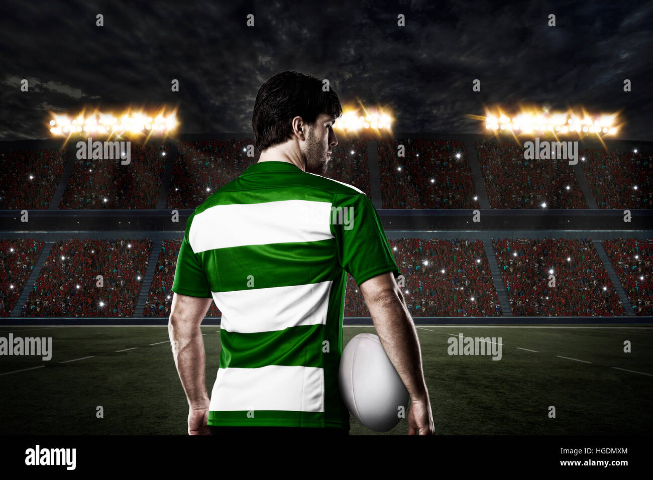 Rugby player in a green uniform on a stadium Stock Photo - Alamy