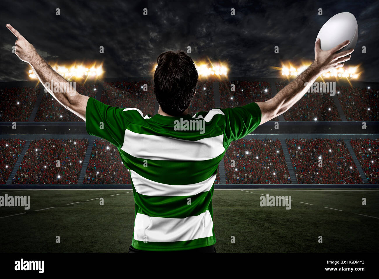 Rugby player in a green uniform celebrating on a stadium Stock Photo ...