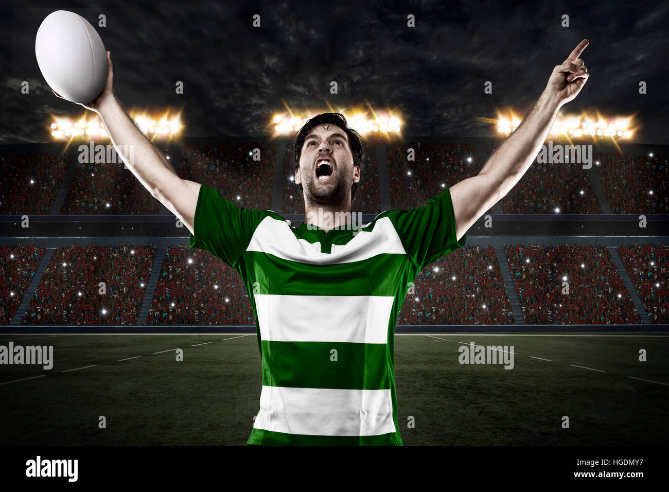 Rugby player in a green uniform celebrating on a stadium Stock Photo ...