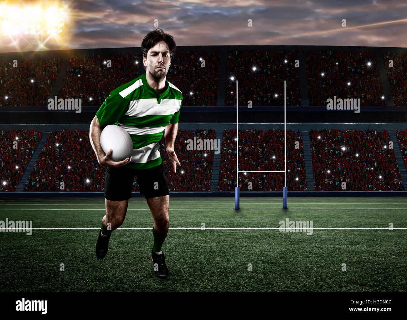 Rugby player in a green uniform running on a stadium Stock Photo - Alamy
