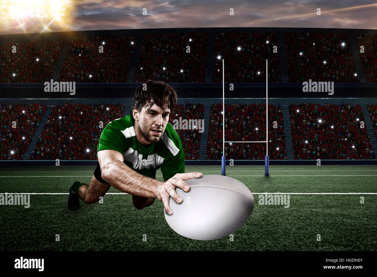 Rugby player in a green uniform scoring on a stadium Stock Photo - Alamy