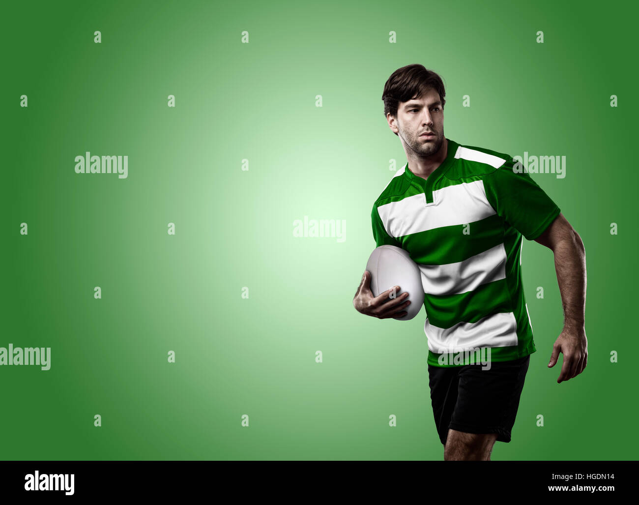 Rugby player in a green uniform on a green backgrond Stock Photo - Alamy