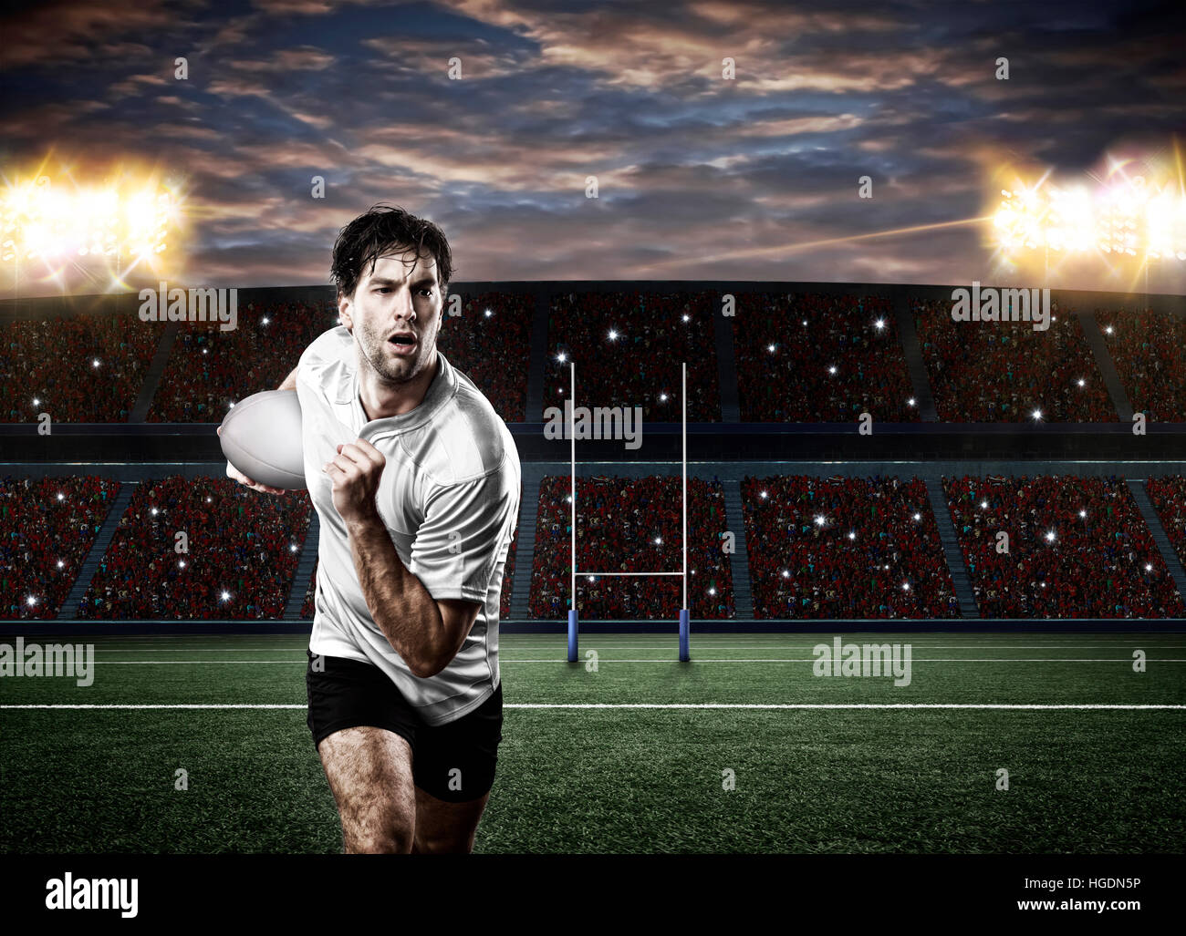 Rugby player in a white uniform running on a stadium Stock Photo - Alamy
