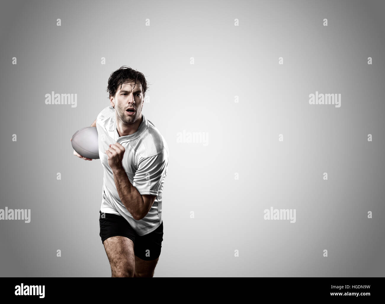 Rugby player in a white uniform running on a white background Stock ...