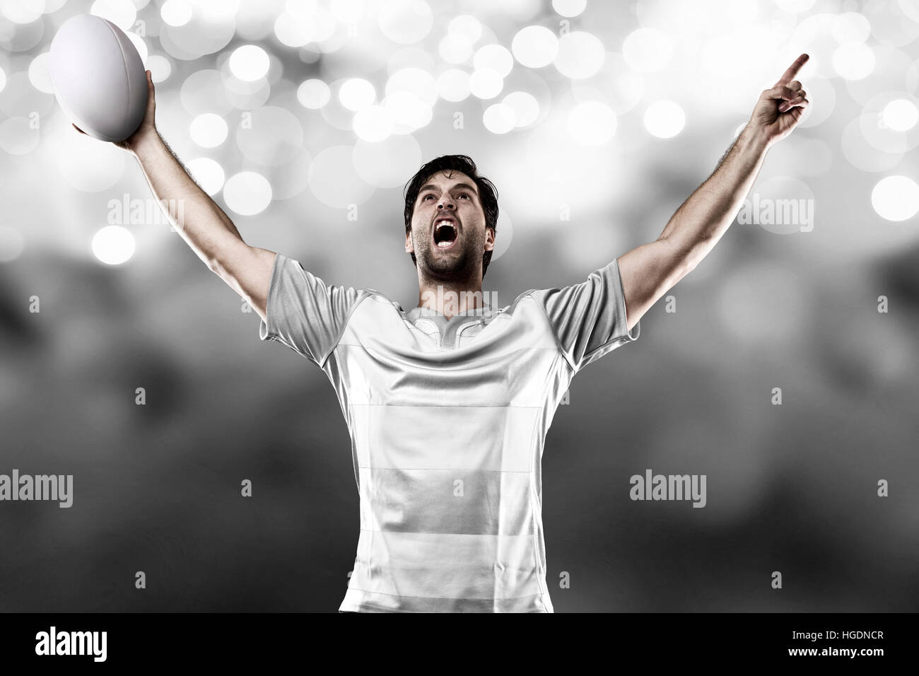 Rugby player in a white uniform celebrating on a white lights ...