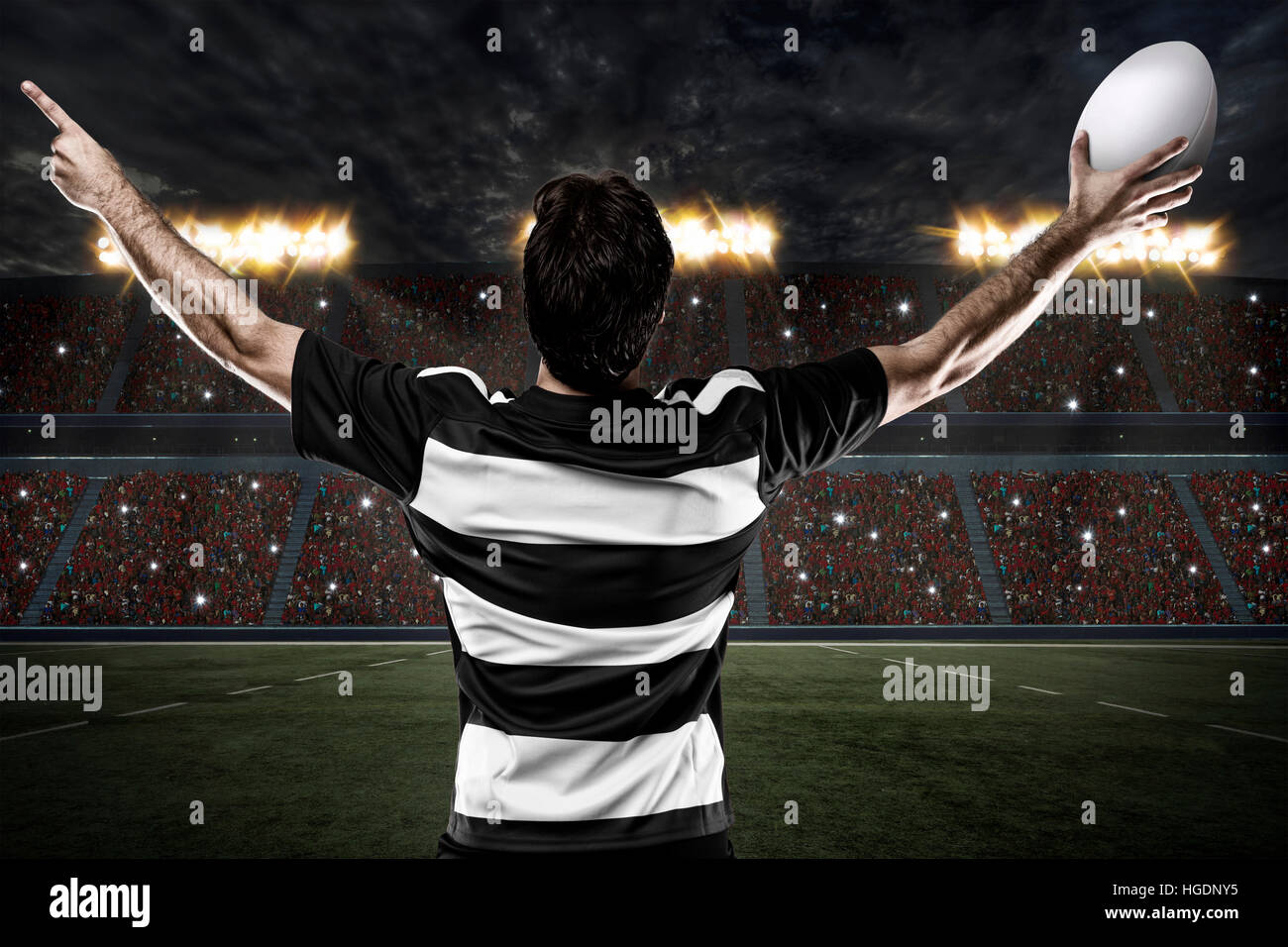 Rugby player in a black uniform celebrating on a stadium Stock Photo ...