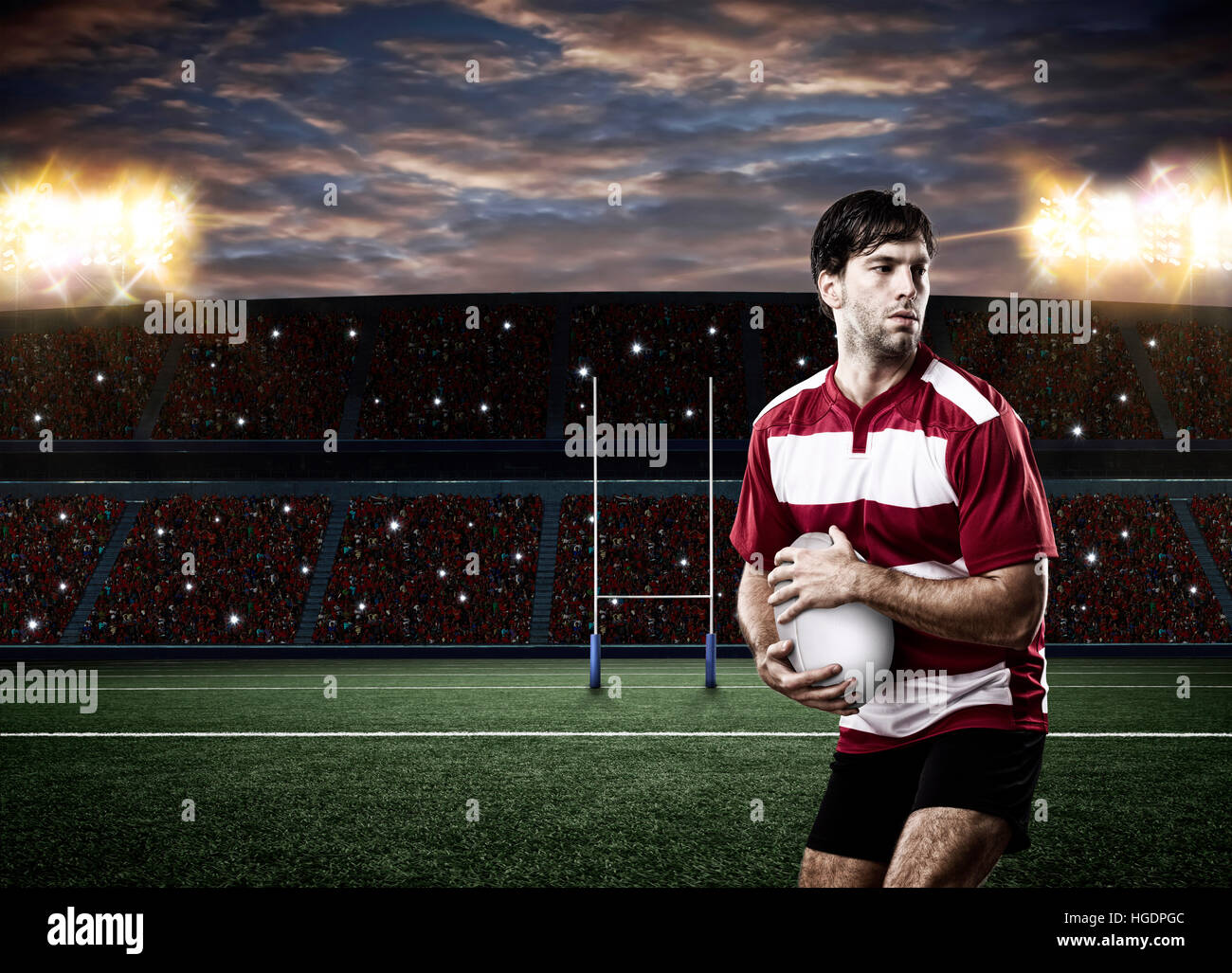 Rugby player in a red uniform on a stadium Stock Photo - Alamy