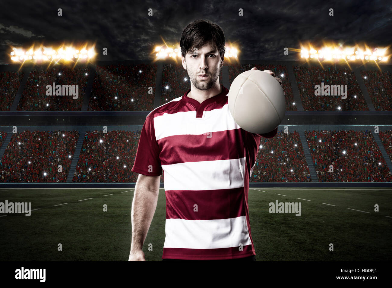 Rugby player in a red uniform on a stadium Stock Photo - Alamy