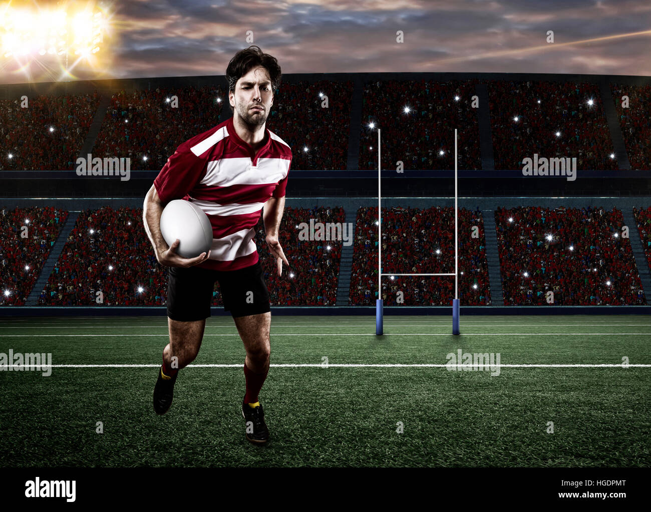 Rugby player in a red uniform running on a stadium Stock Photo - Alamy
