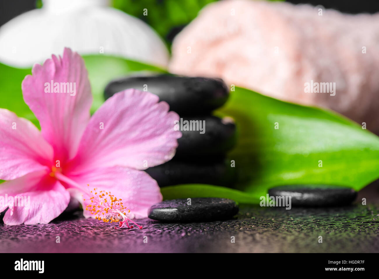 beautiful spa background of pink hibiscus flower, leaves, towel and ...