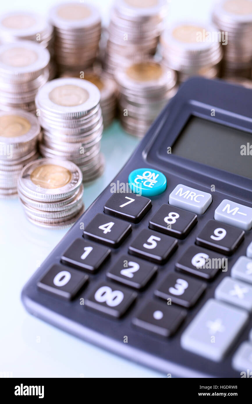 Couns and calculator on white background. Studio shot Stock Photo - Alamy