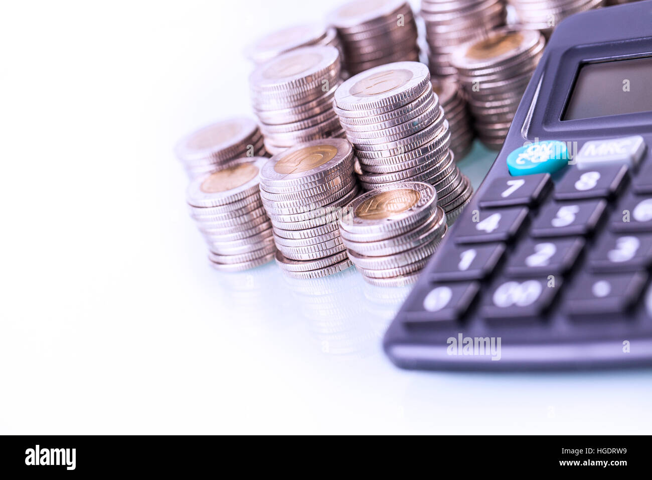 Couns and calculator on white background. Studio shot Stock Photo - Alamy