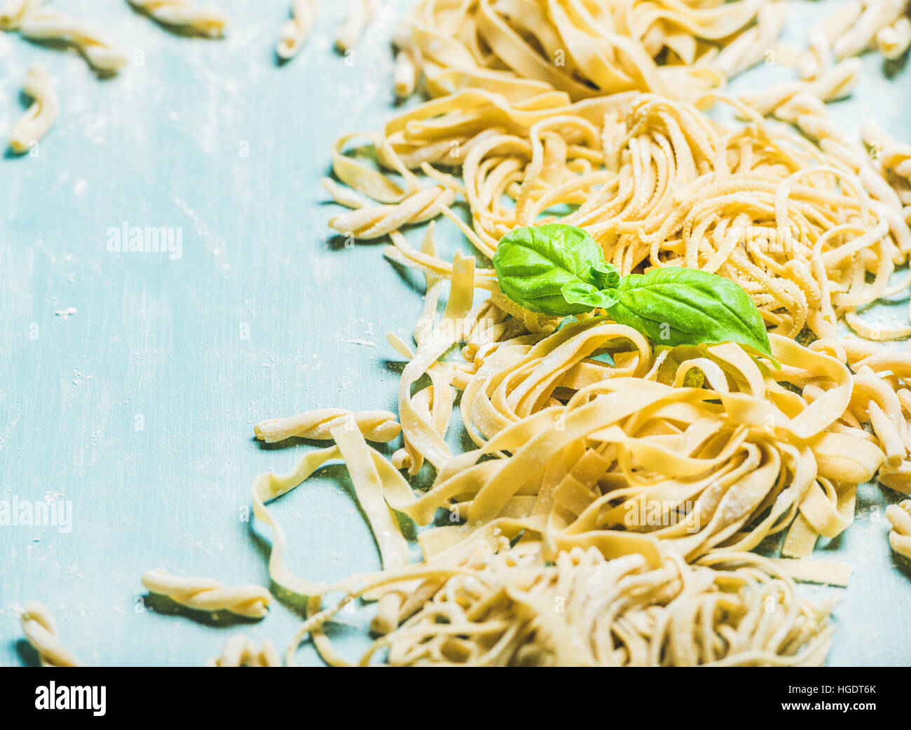 Various homemade fresh uncooked Italian pasta with flour and fresh ...