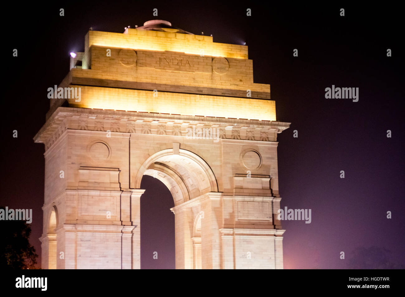 India gate at night with multicolored lights. This landmark is one of ...