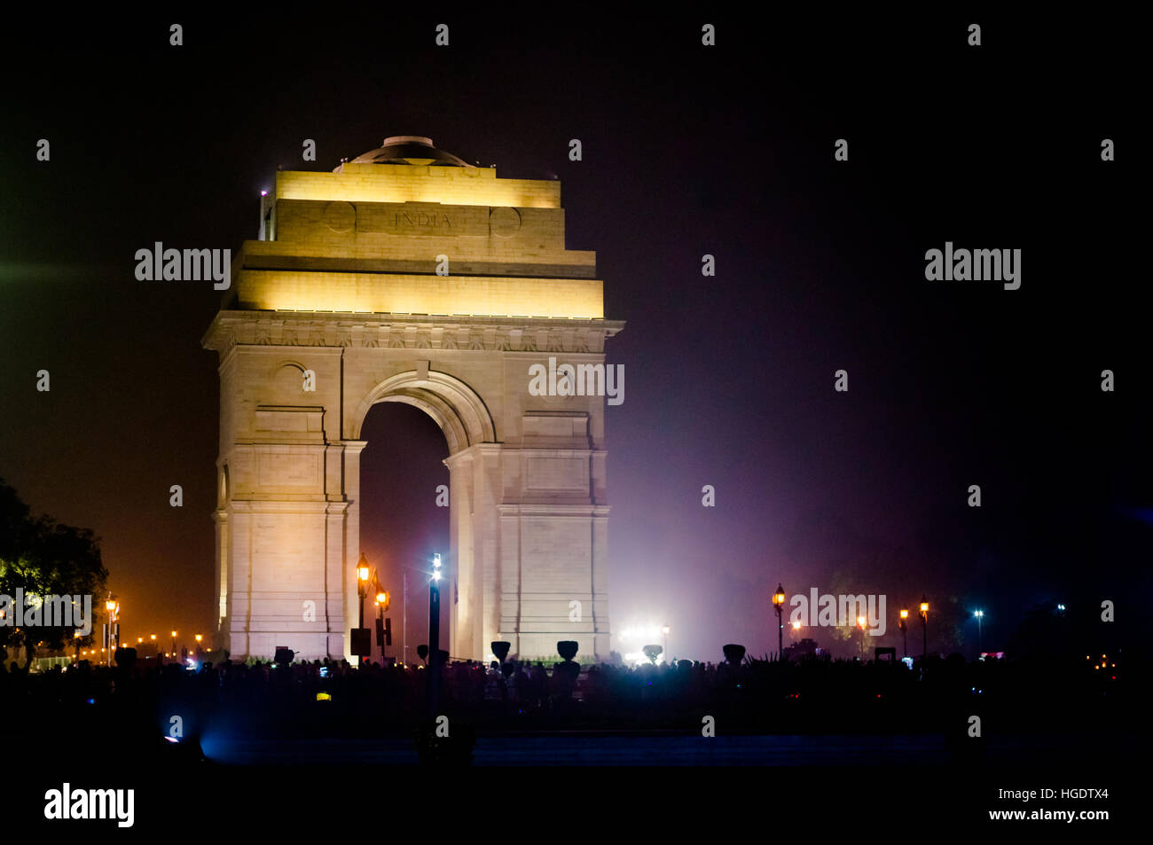 India gate at night with multicolored lights. This landmark is one of ...