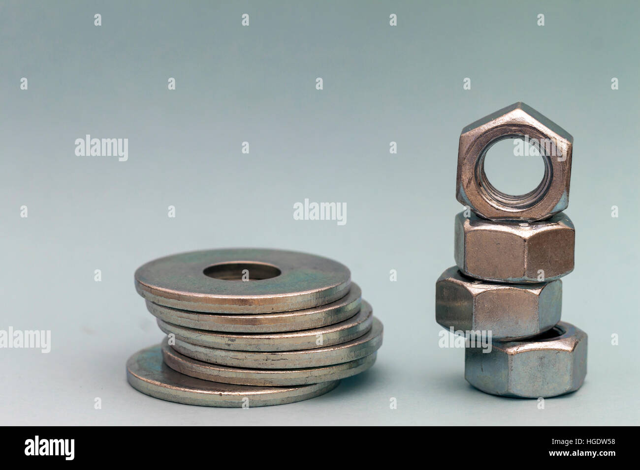 Joiner's accessories. Stacks of metal screw washers and nuts isolated ...