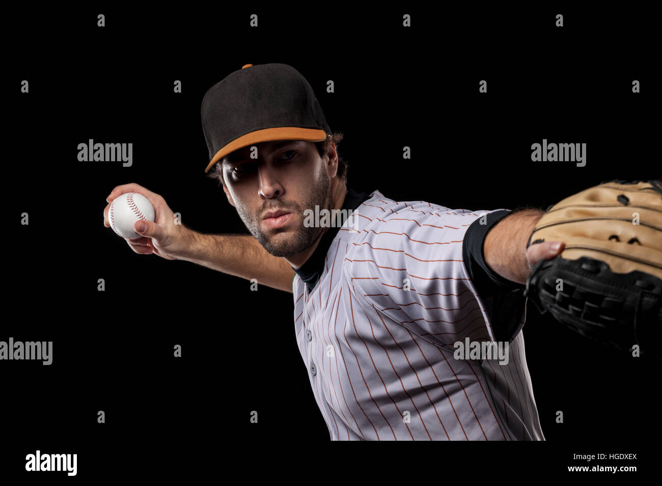 Baseball Player throwing a ball on a black background. Studio Shot ...