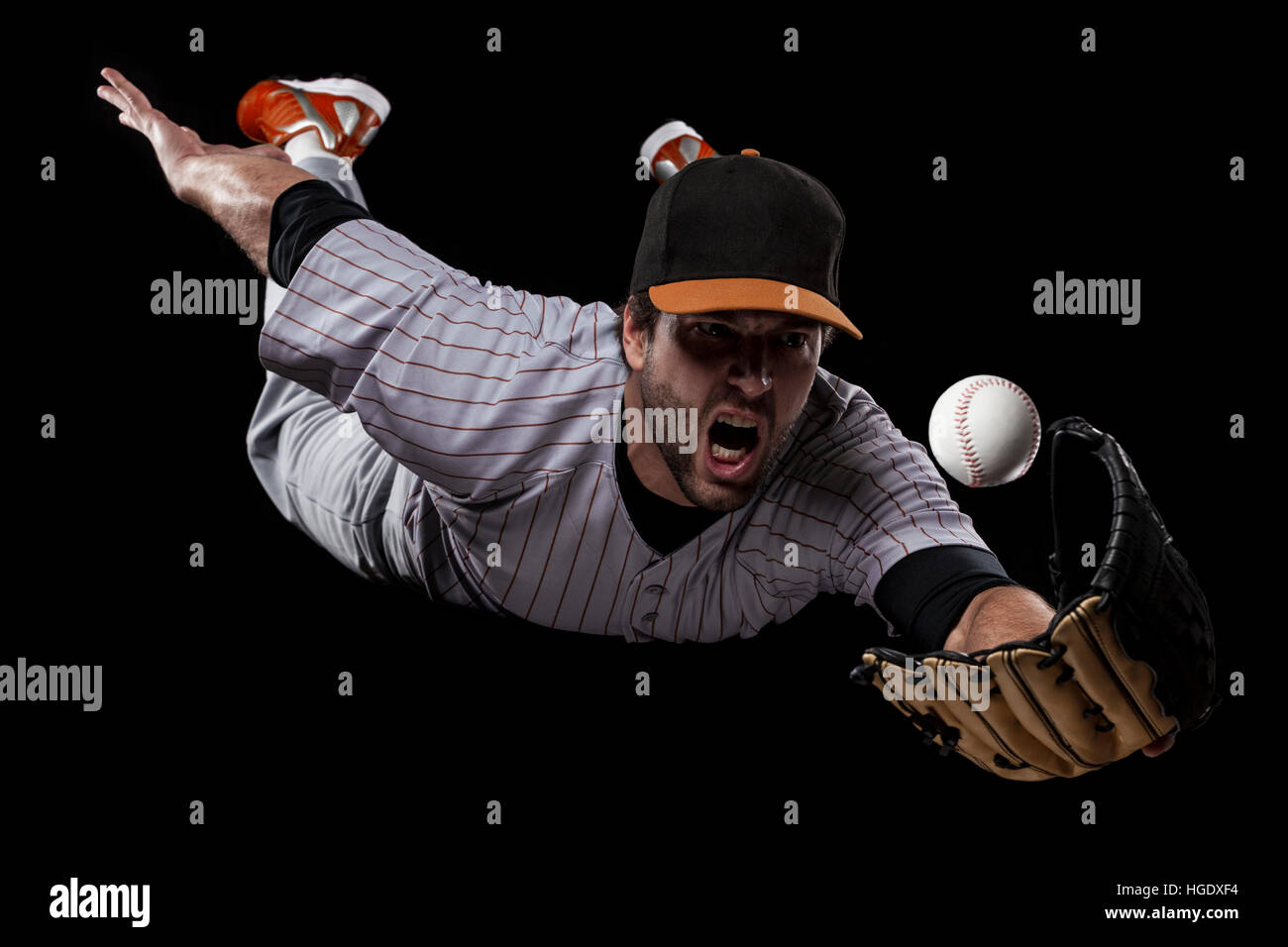 Baseball Player catching a ball on a black background. Studio Shot ...