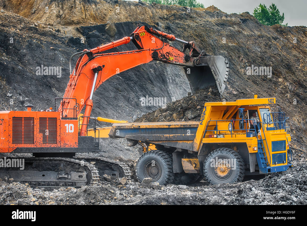 NOVOKUZNETSK, RUSSIA - JULY 26, 2016: Big yellow mining trucks and ...
