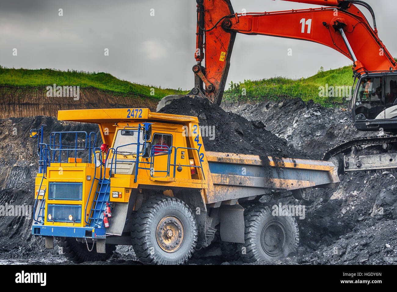 NOVOKUZNETSK, RUSSIA - JULY 26, 2016: Big yellow mining trucks and ...