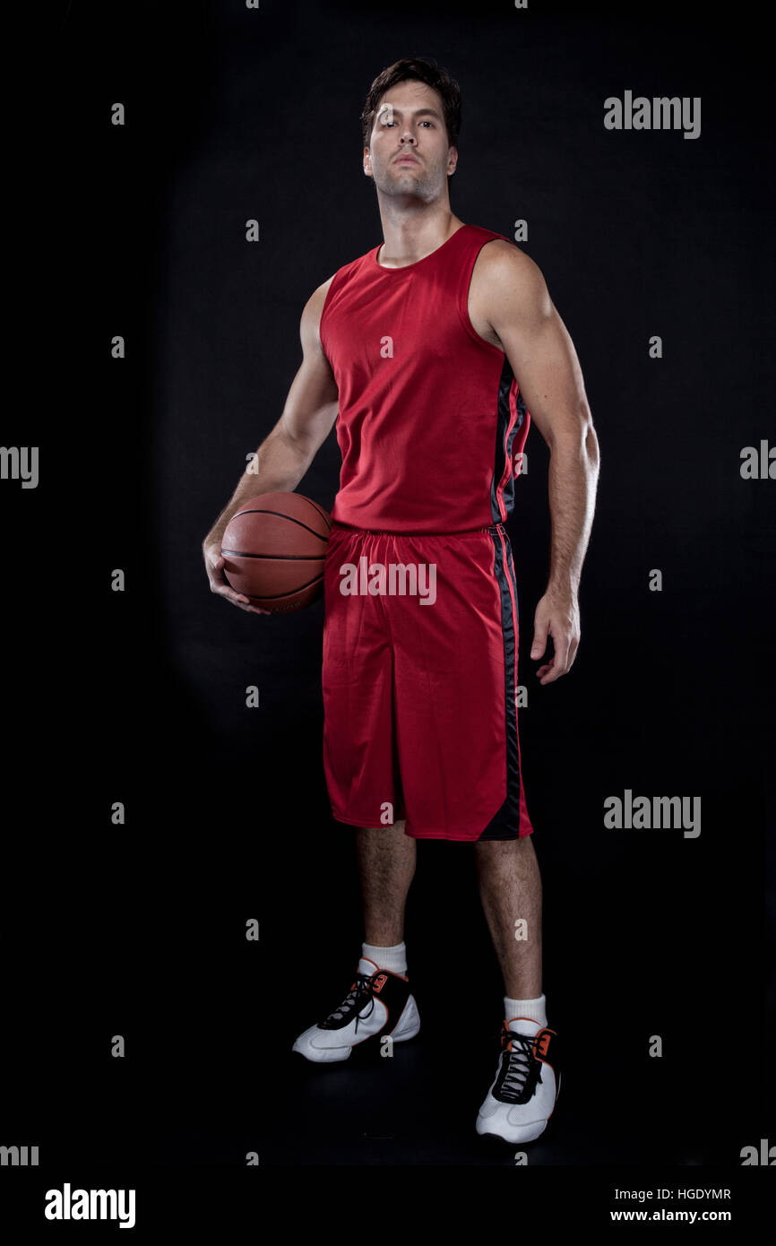 Basketball player with a ball in his hands and a red uniform ...