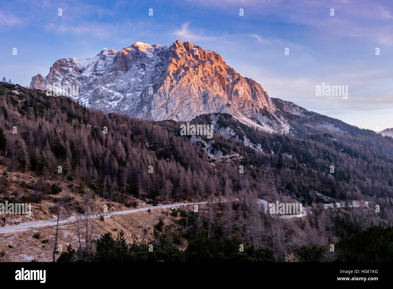Rocky mountain summit at sunset with a twisting road below Stock Photo ...