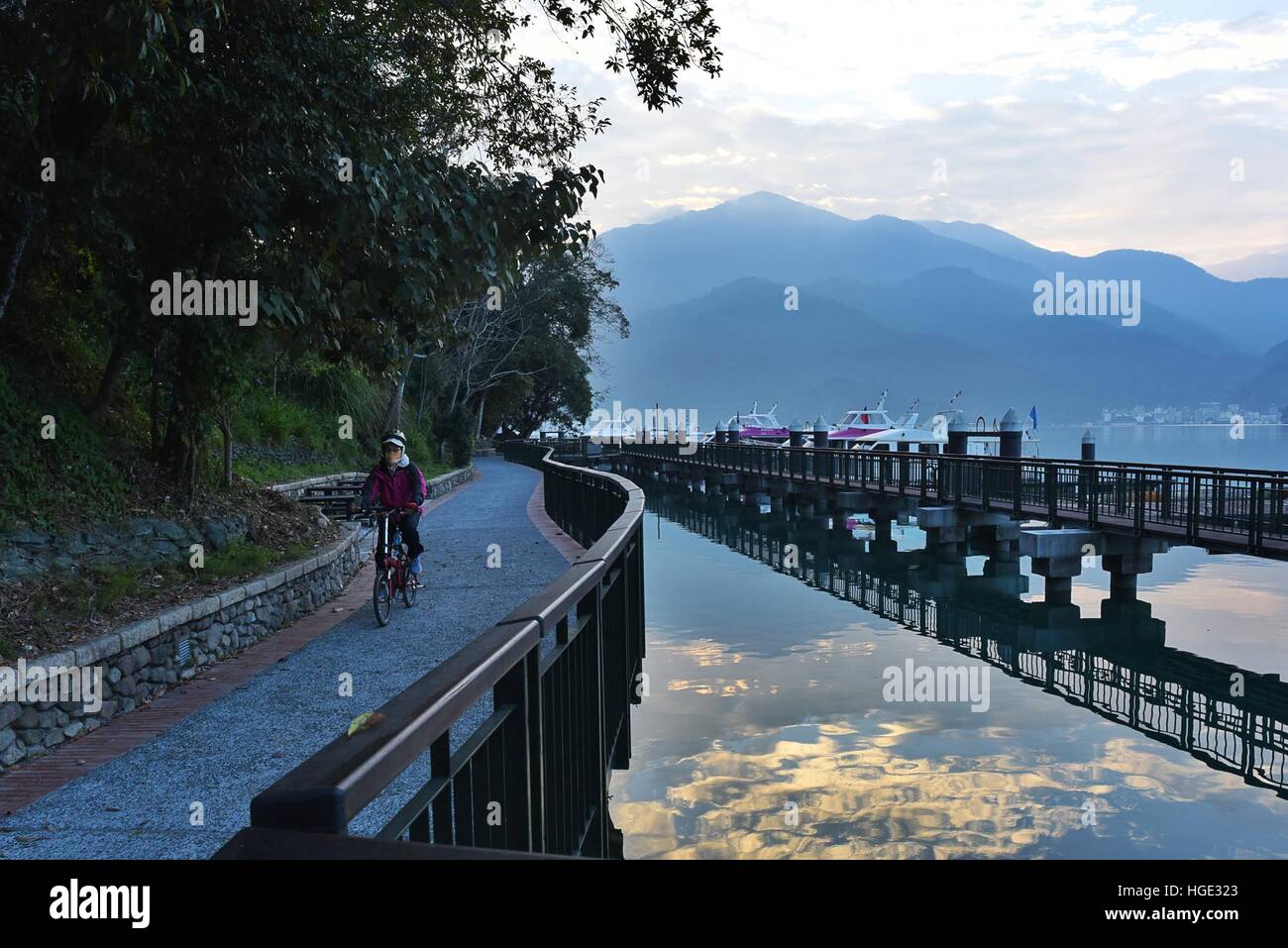 Nantou, China's Taiwan. 8th Jan, 2017. A rider rides along the lakeside ...