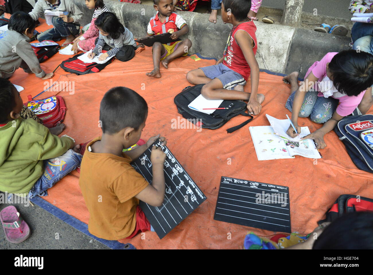Dhaka, Bangladesh. 08th Jan, 2017. A group of street children studies ...