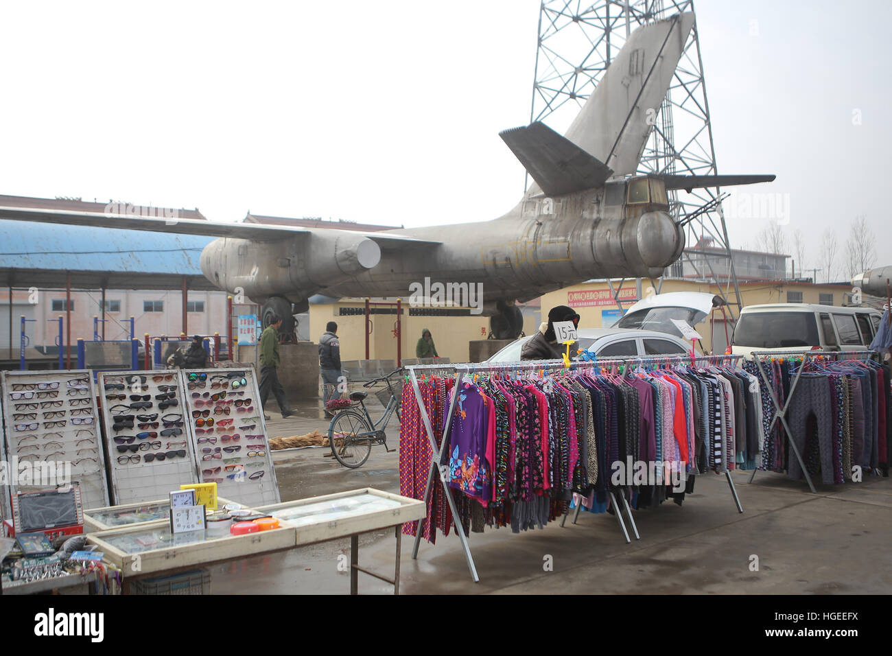 Binzhou, China. 9th Jan, 2017. Villagers attend a fair under giant ...