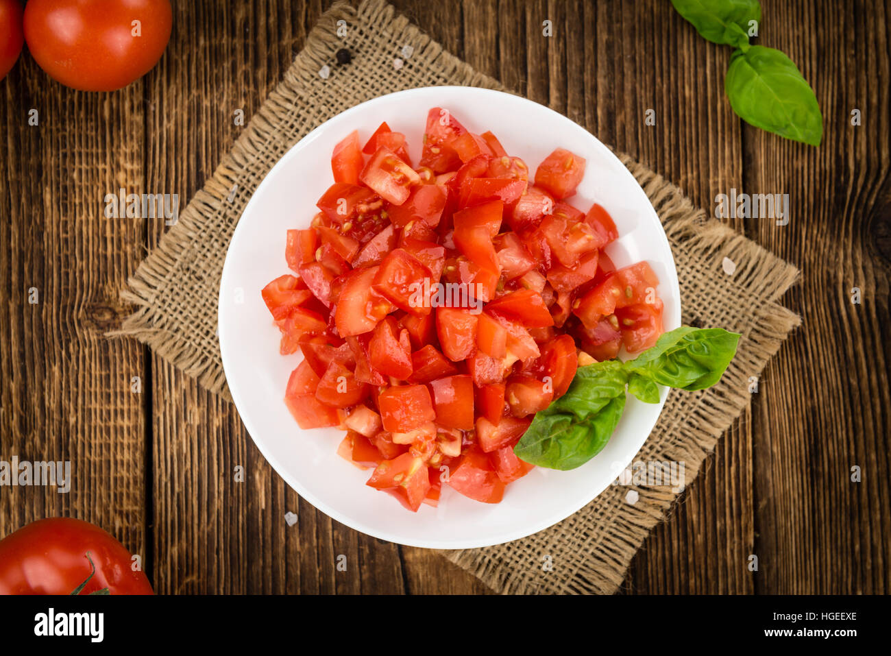 Cutted Tomatoes on an old wooden table as detailed close-up shot ...