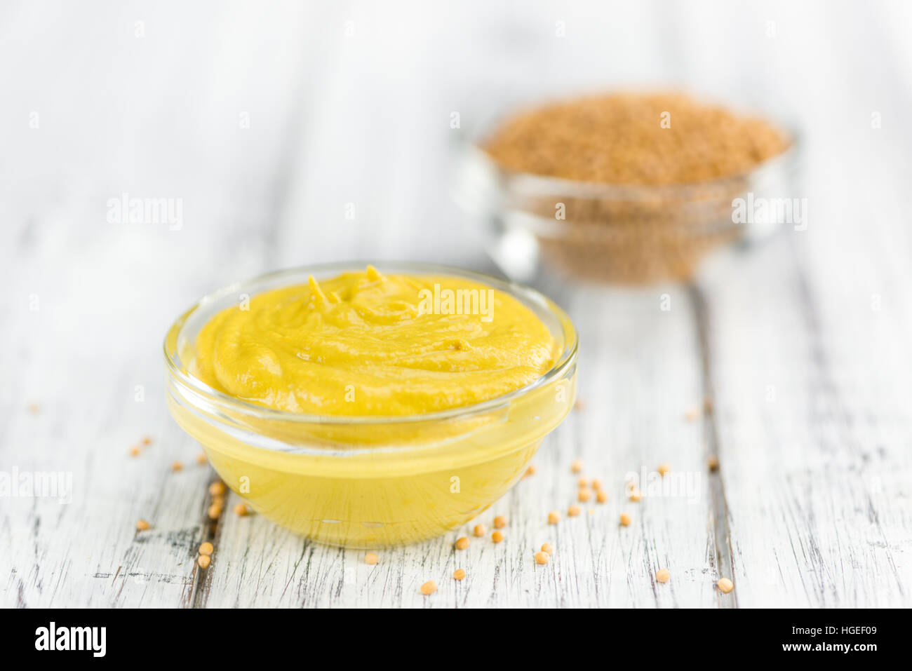 Portion of homemade Mustard on wooden background (selective focus ...