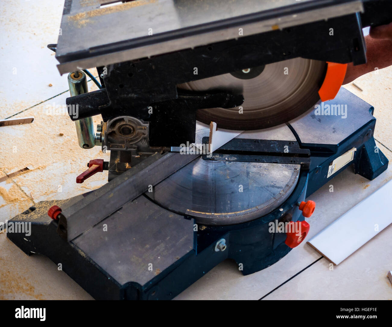 Closeup view wooden board electric circular saw. Focus is on the tools ...