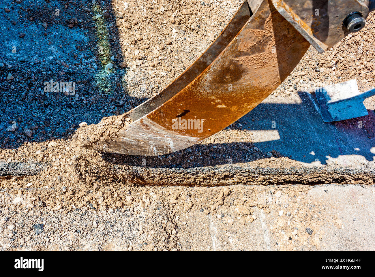 Mini excavator with narrow bucket for laying fiber-optic cable line ...