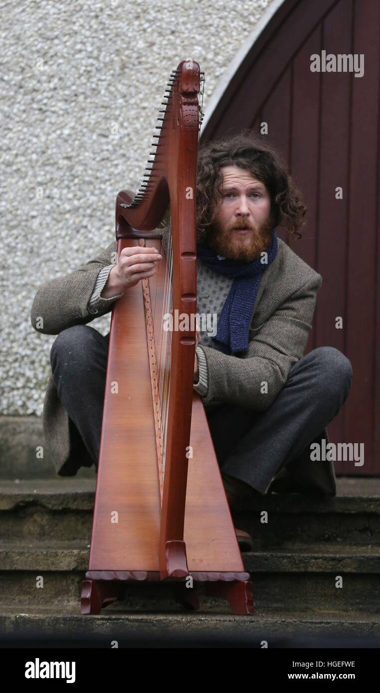 A musician plays the harp at the funeral of Therese MacGowan, 87, the ...