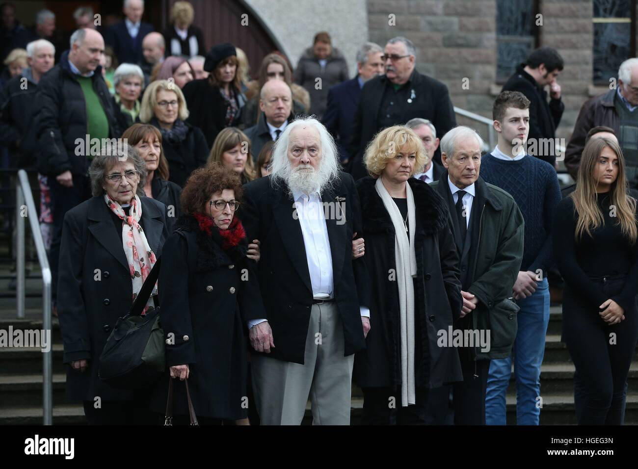 Therese MacGowan's husband Maurice (centre) is comforted by family ...