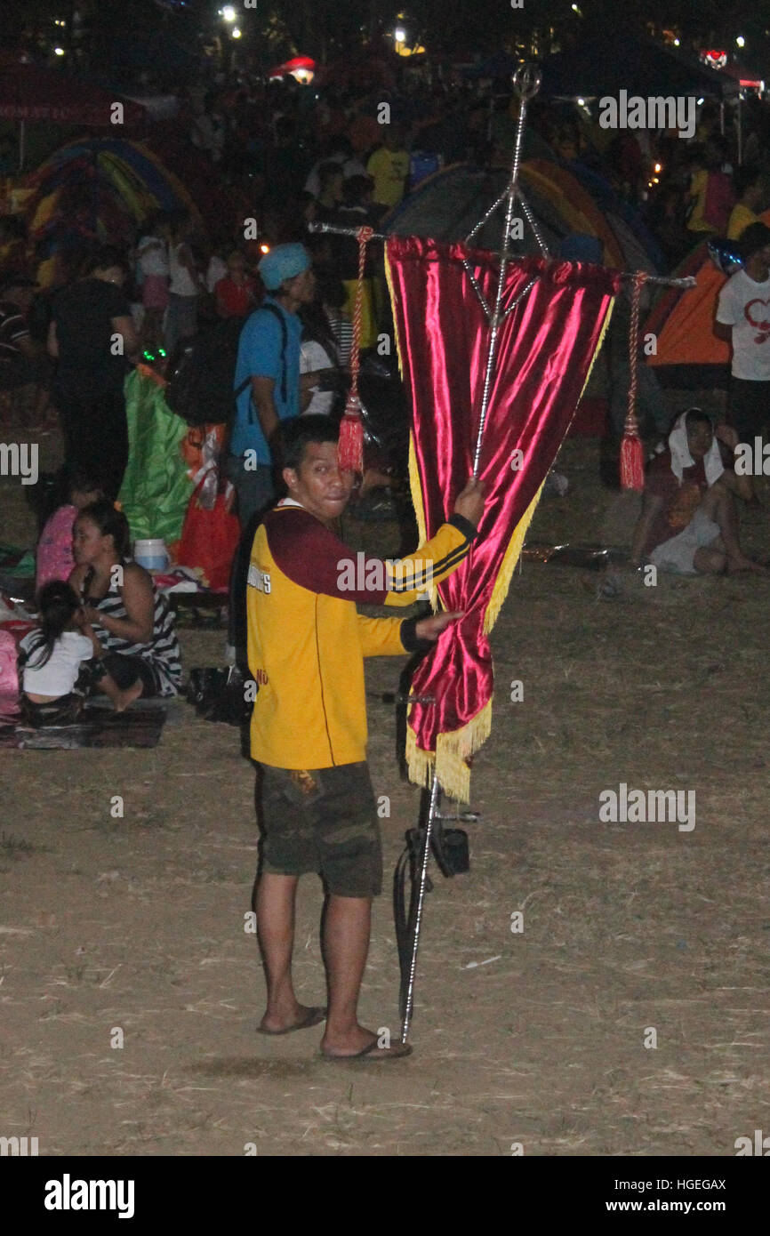 Manila, Philippines. 08th Jan, 2017. A flagbearer of a devotees' group ...