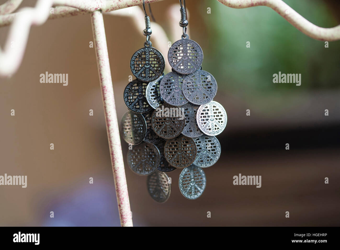 Metal earrings with Peace symbol Stock Photo - Alamy