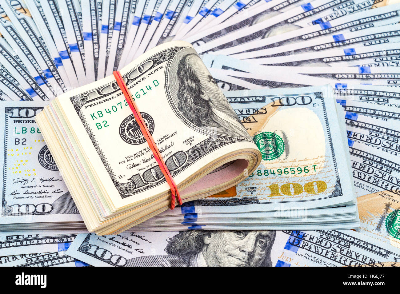 Folded dollar bills wrapped by rubber band over dollars banknotes Stock ...