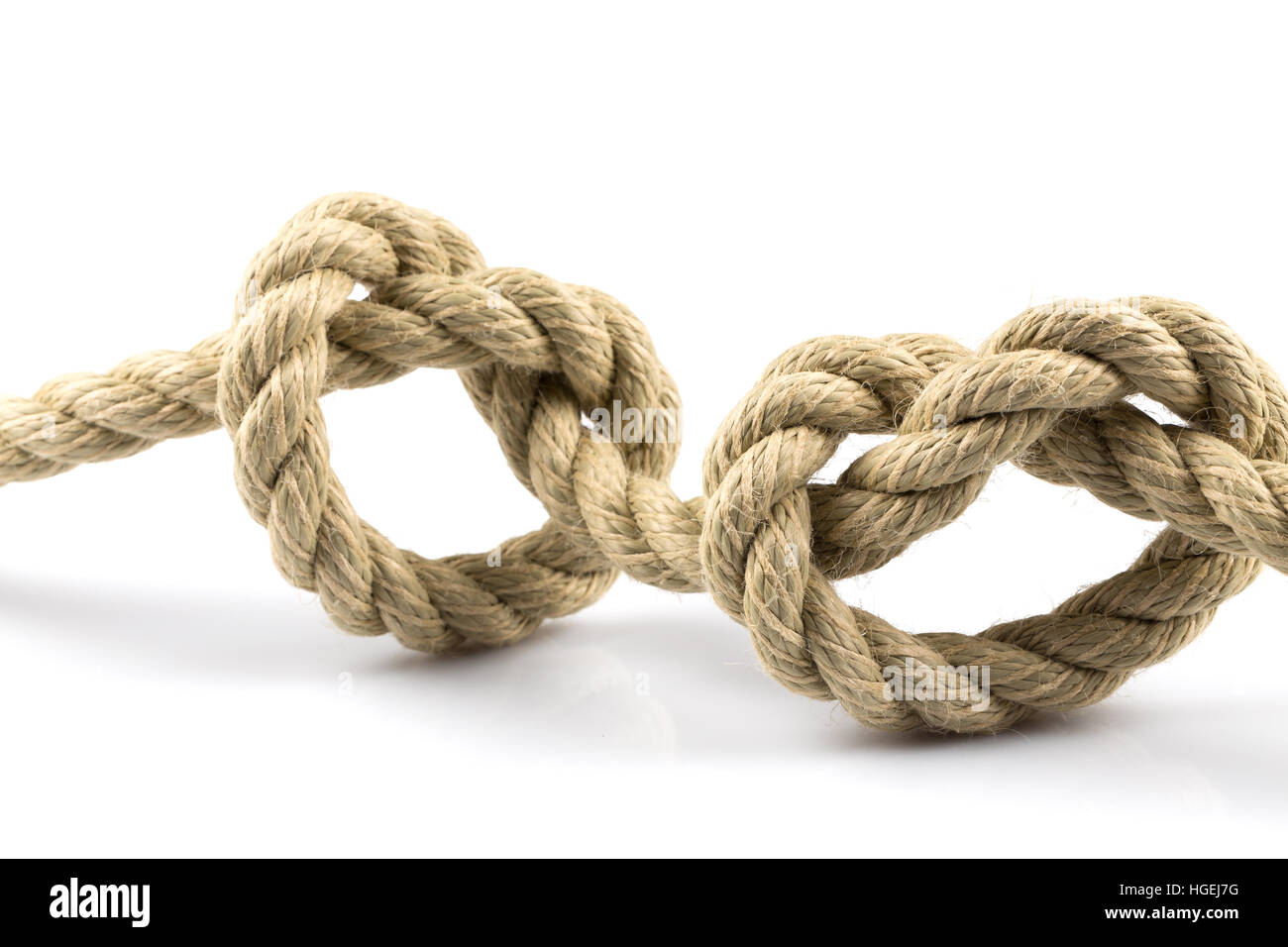 Two heart shape knots of rope isolated on white background Stock Photo ...