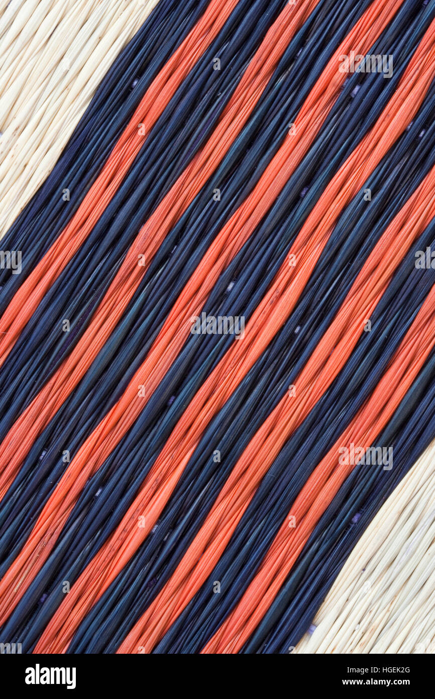 Black, red and straw colour woven raffia Stock Photo - Alamy