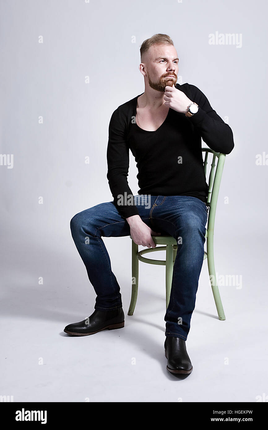 Handsome man, seated Stock Photo - Alamy